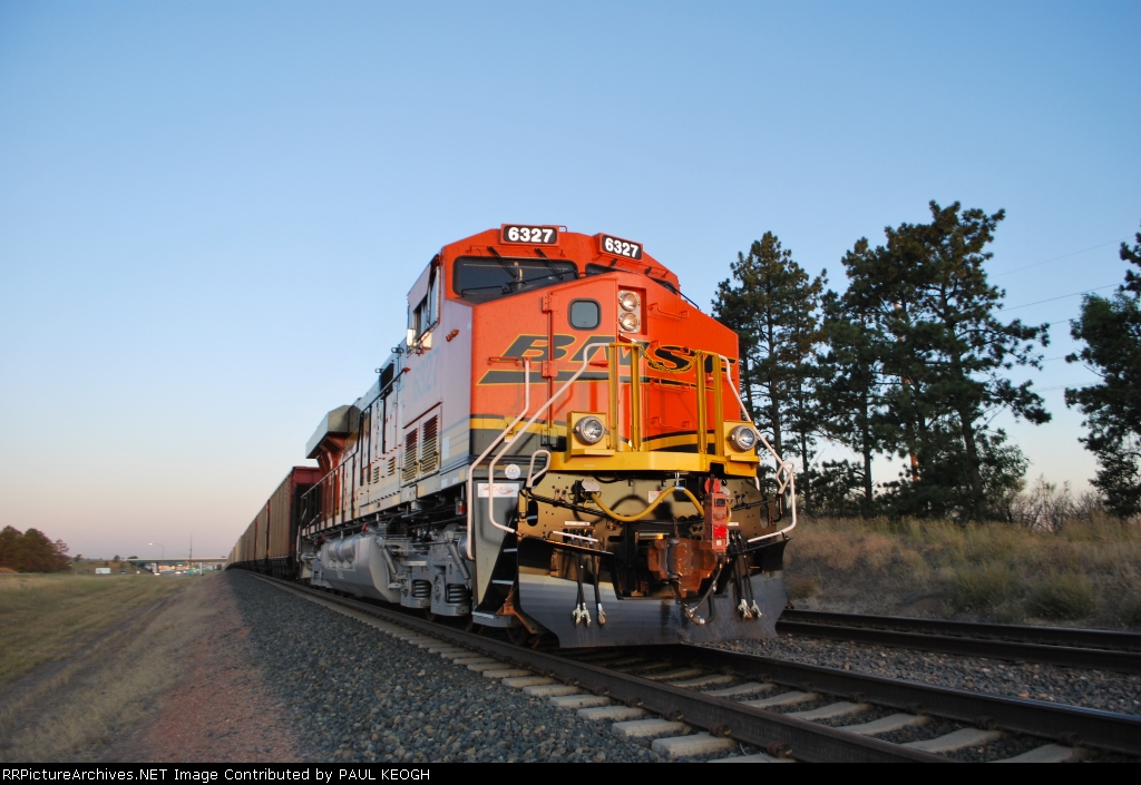 BNSF 6327 rear DPU reflects the early morning rays as she waits to roll west behind her sister ...